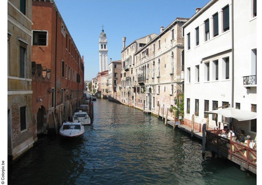 Photo of downtown Venice with a canal and historic buildings along the ...